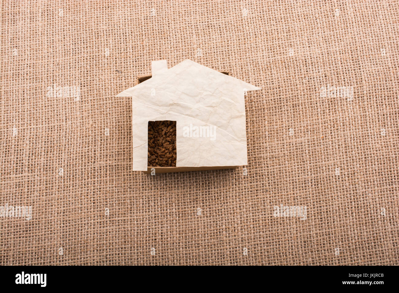 Little house shape cut out of paper on a canvas background Stock Photo ...