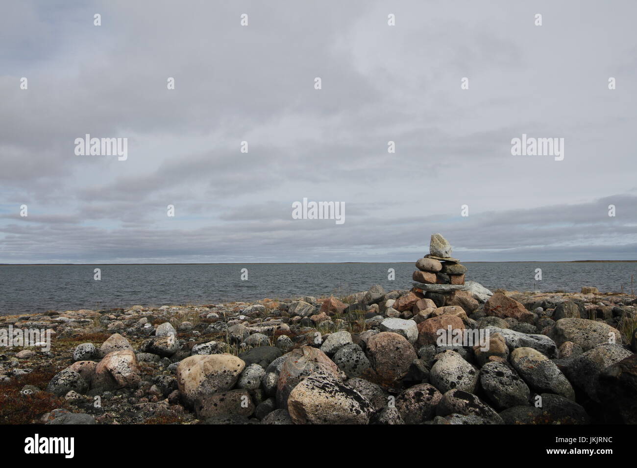 Single Inukshuk or Inuksuk along the arctic coast near Arviat, Nunavut ...