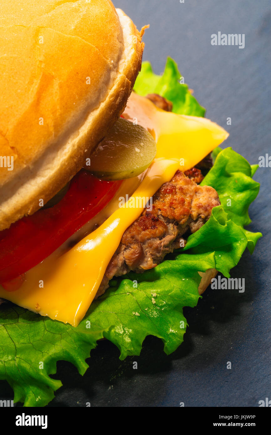 Cheeseburger closeup on a gray background Stock Photo - Alamy