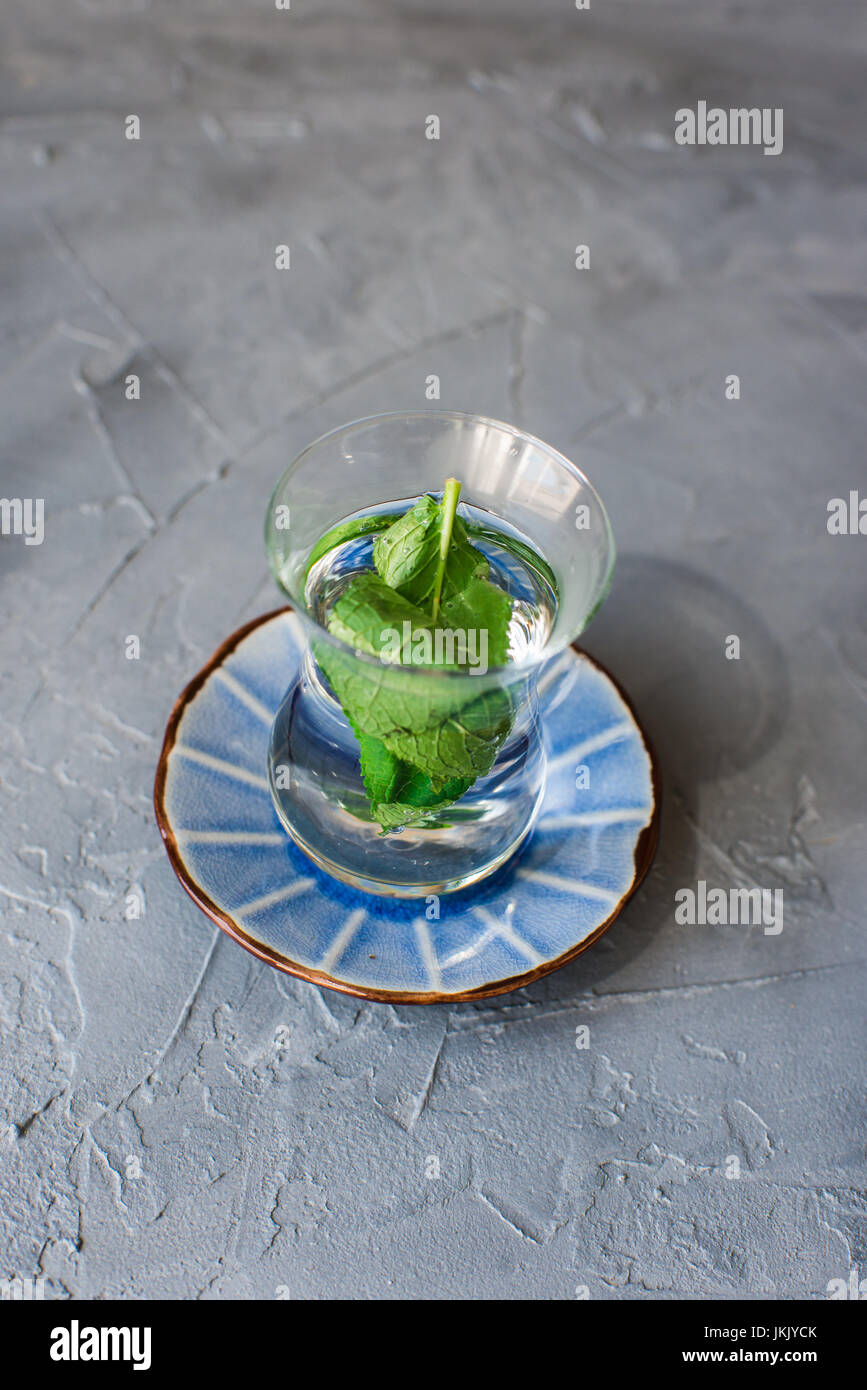 Traditional turkish mint tea in a glass on concrete table Stock Photo ...