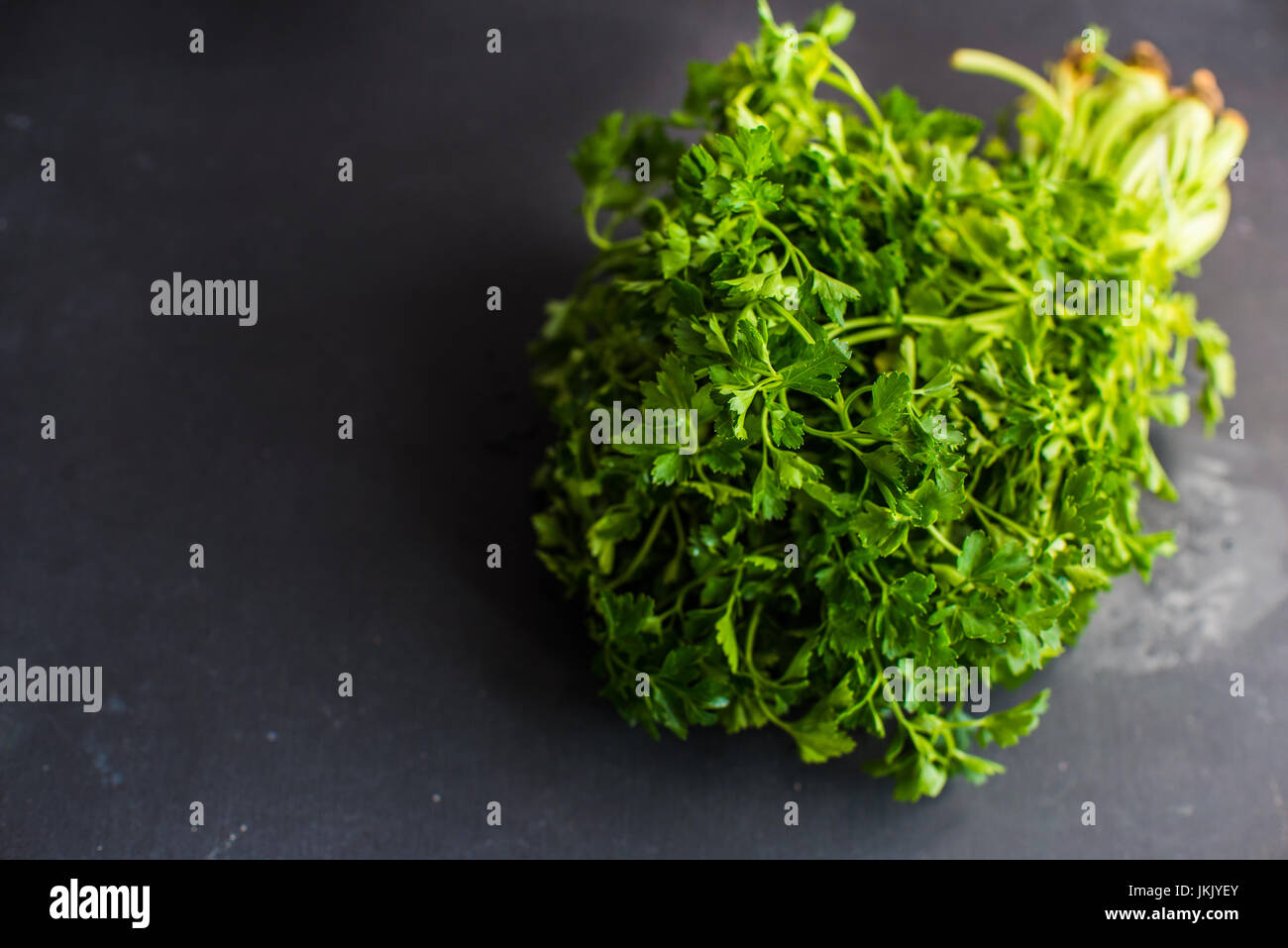 Fresh parsey herb on dark background with copyspace Stock Photo - Alamy