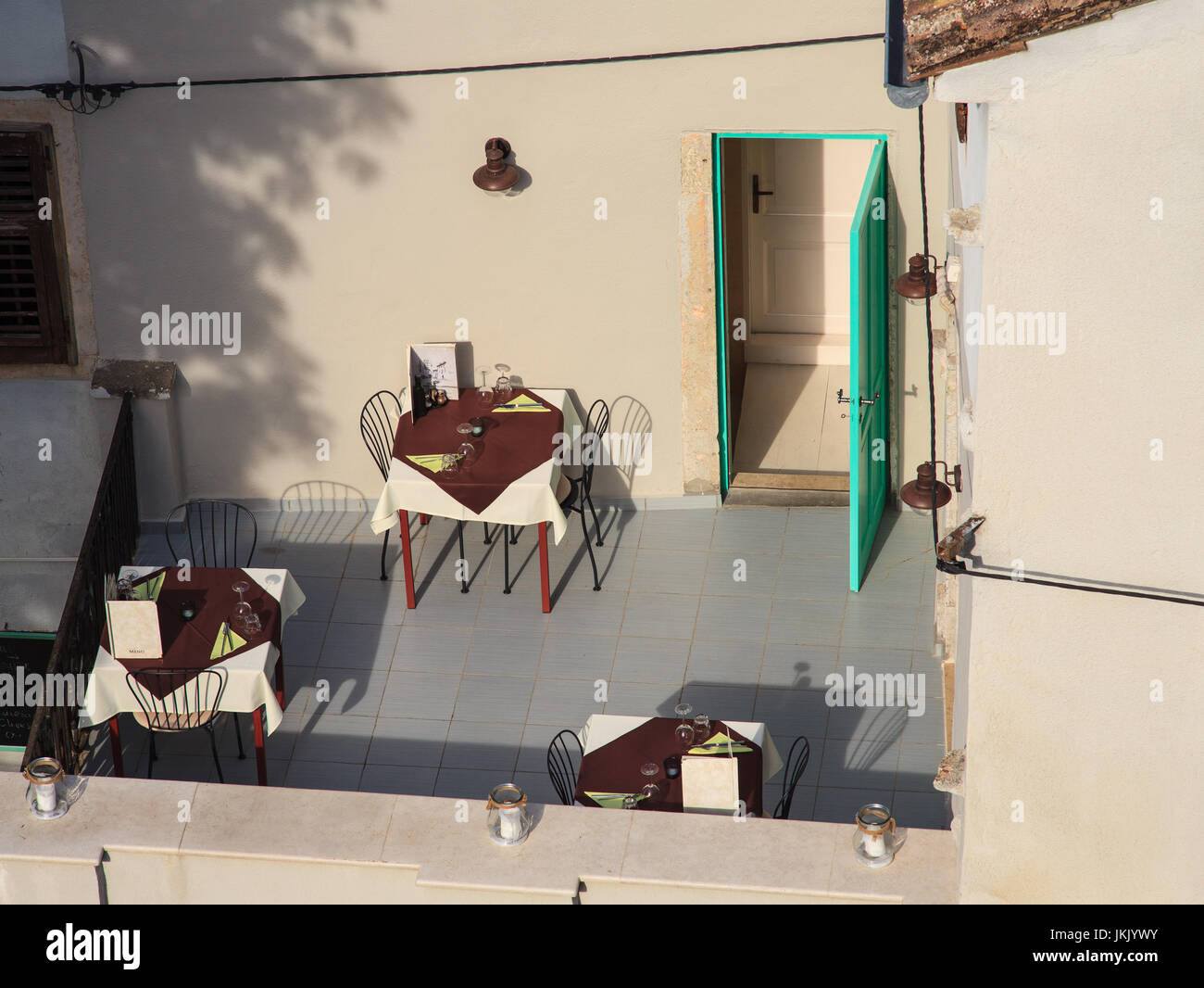 View of three Restaurant tables in a terrace Stock Photo - Alamy