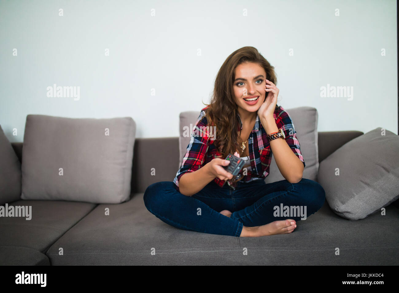 Young woman watching tv in the room Stock Photo - Alamy