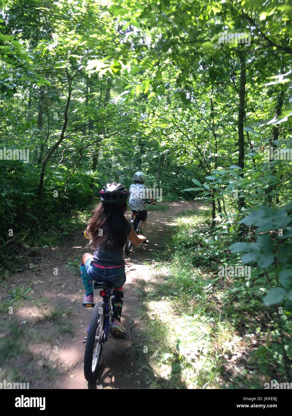 Kids biking on a trail Stock Photo - Alamy