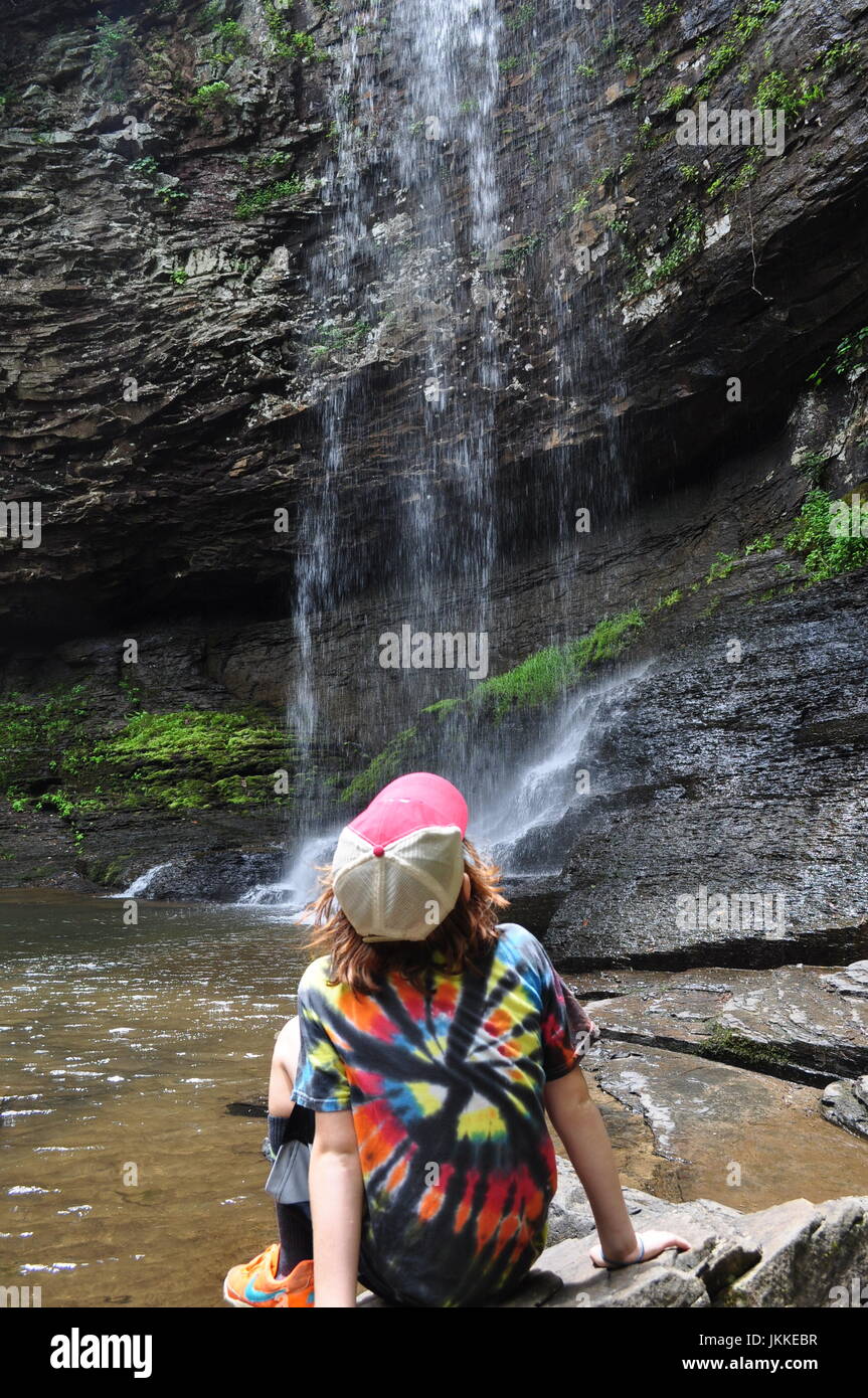 Boy looking at a waterfall Stock Photo - Alamy