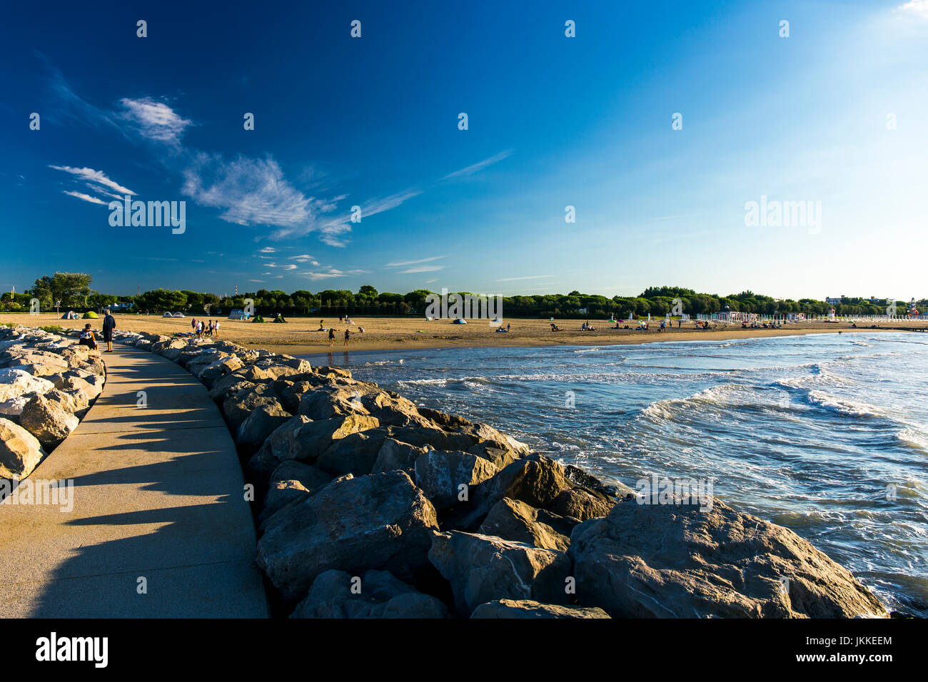 View at the beach and the seashore from a stone pier.Jesolo, Italy ...