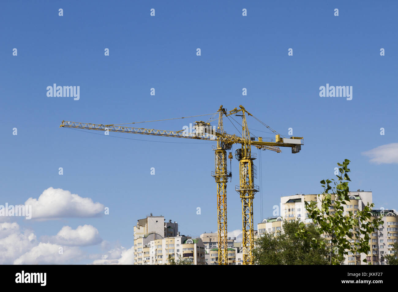 Two tower cranes of yellow color on the construction site Stock Photo ...