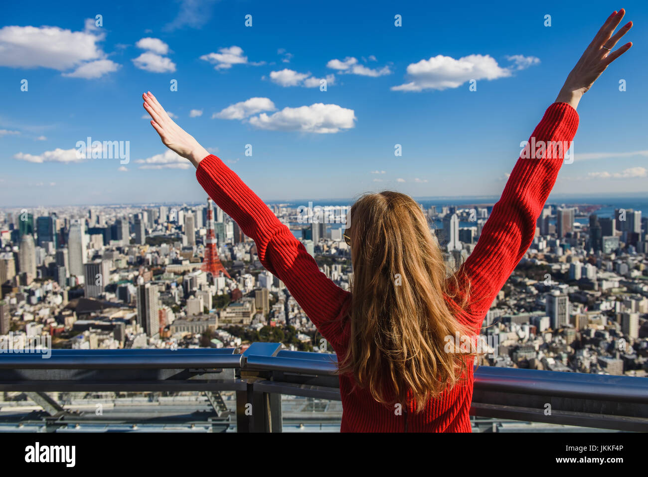 Happy young woman with her hands up Stock Photo - Alamy