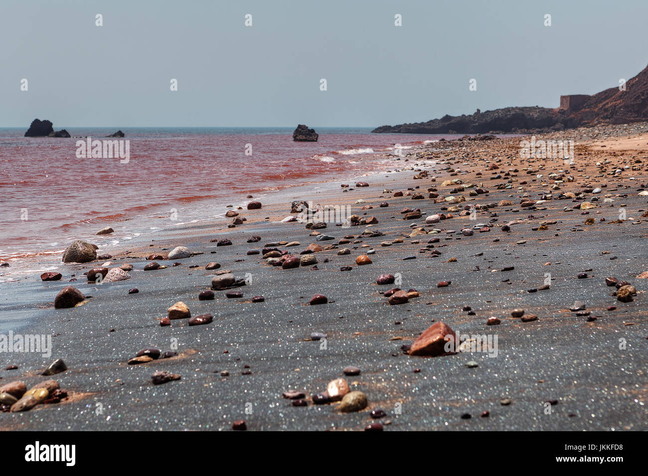 Beach with silver sand and red sea water on Hormuz Island, Hormozgan ...