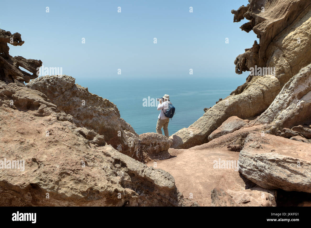 Tourist photographing nature, standing on the edge of a cliff., Iranian ...