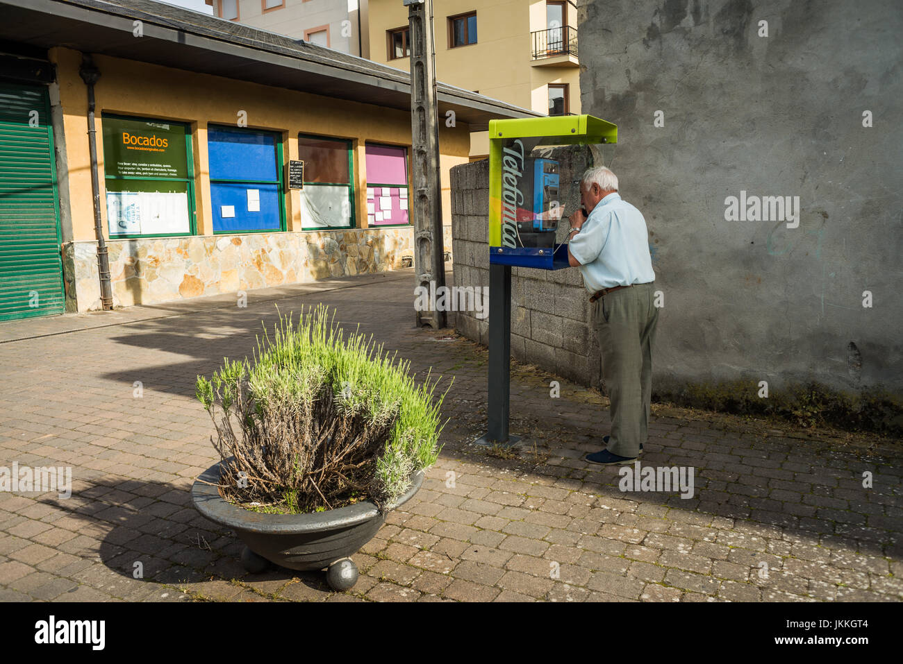 man in a telephone booth in the Cacabelos, Spain. Camino de Santiago ...