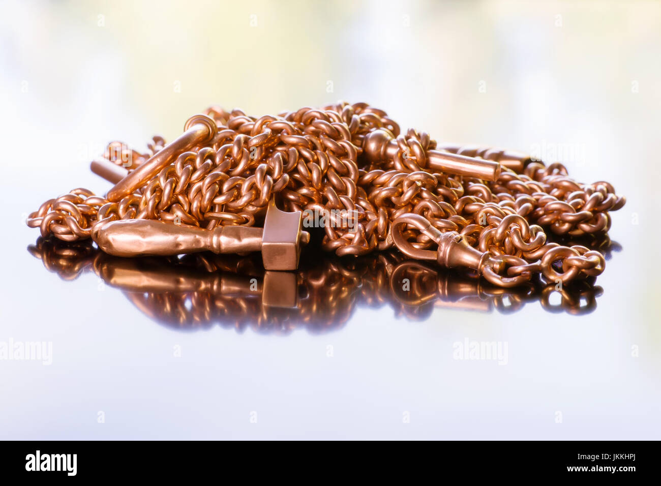 Ancient golden chain and charm. On abstract background with reflection ...