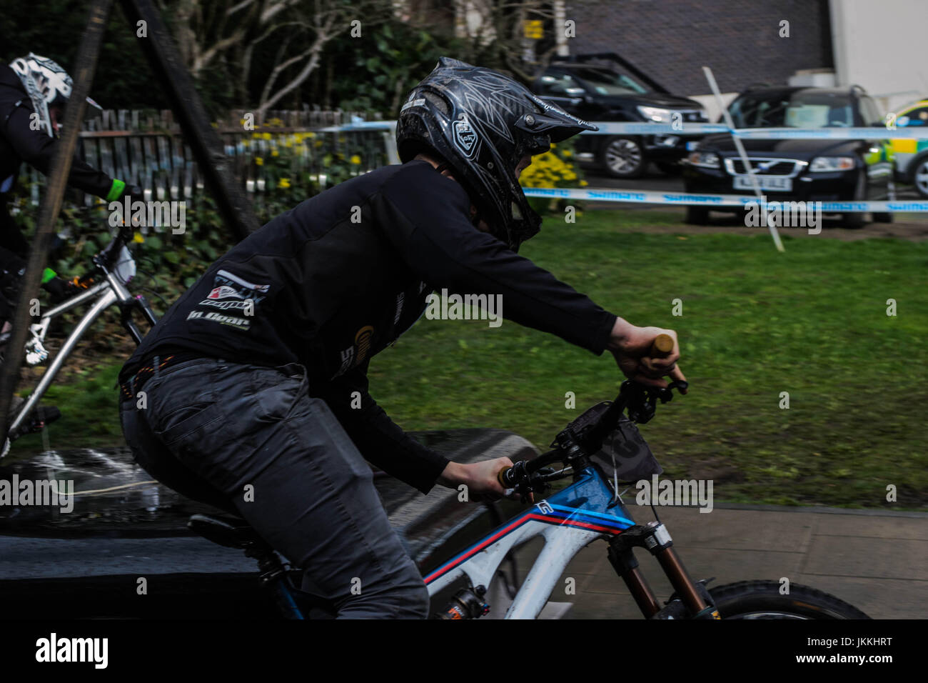Mountain bike riders flying down a hill on a street in Sheffield city ...