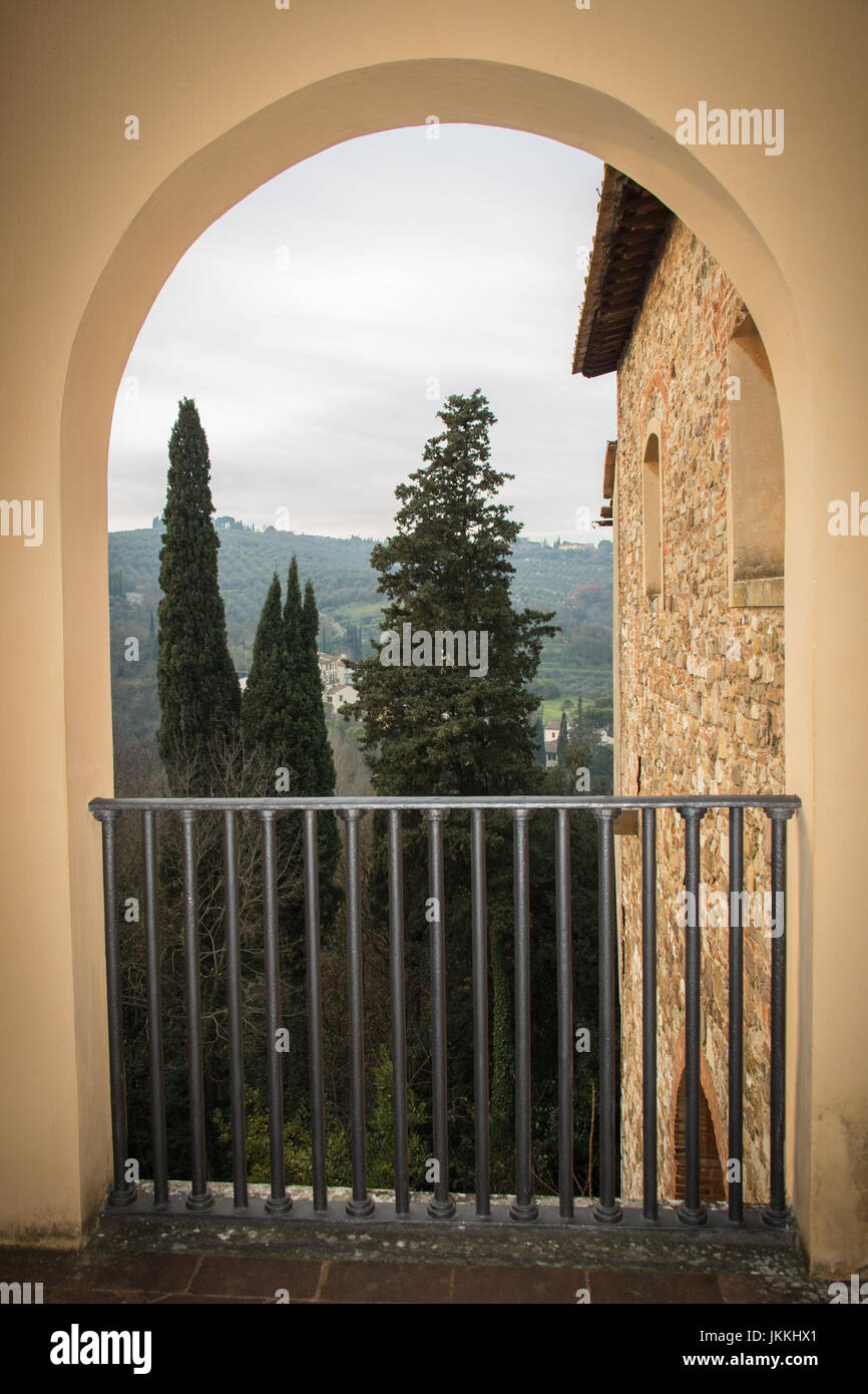 View of trees and building wall from an arch. Florence. Italy. Vignette ...