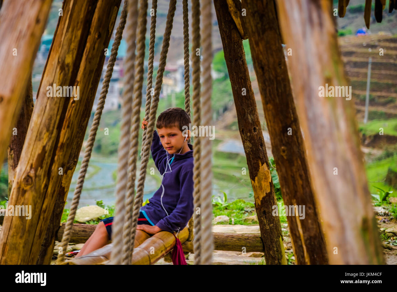 Boy on a swing aroung Sapa, Vietnam - April 2017 Stock Photo - Alamy