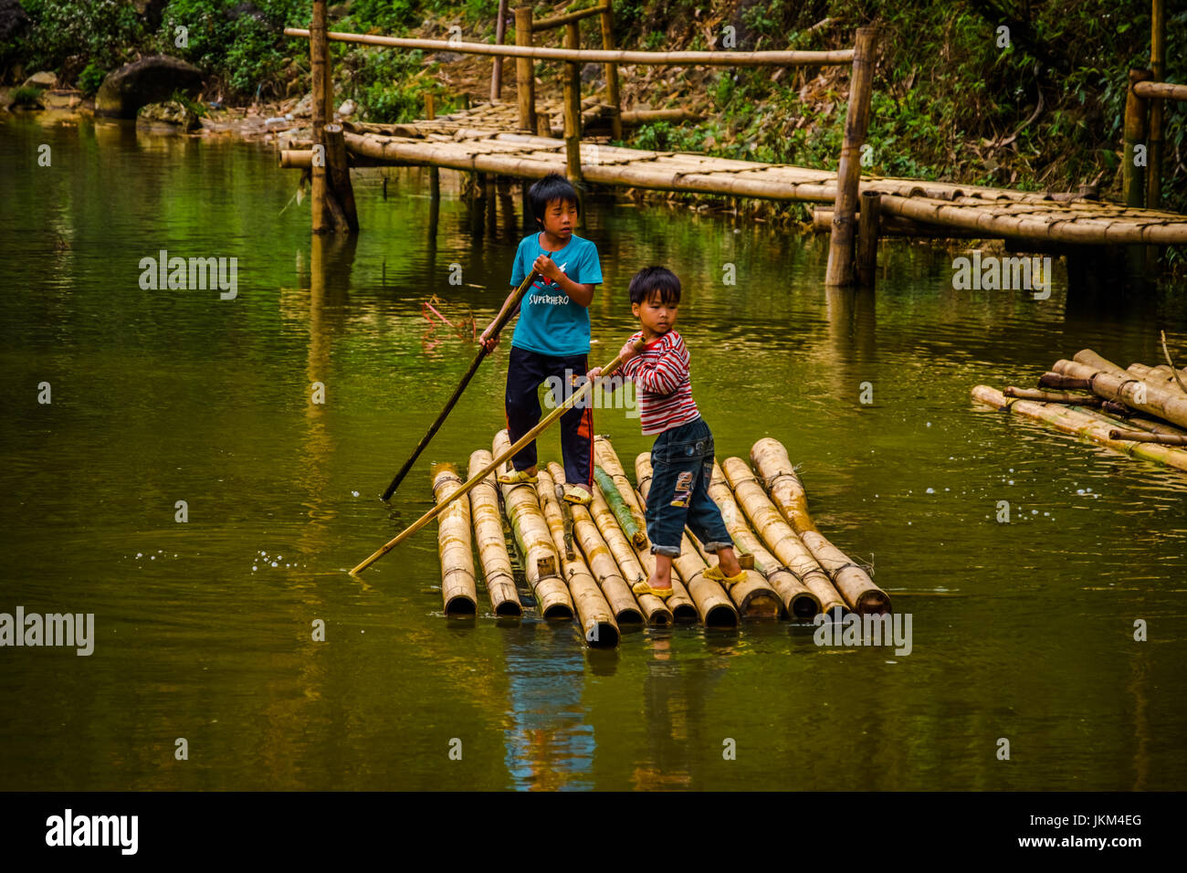 Boys on a raft in river around Sapa, Vietnam - April 2017 Stock Photo ...