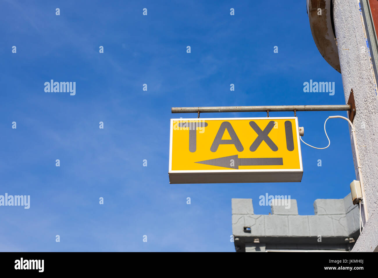 Yellow Taxi Sign against the blue sky Stock Photo - Alamy