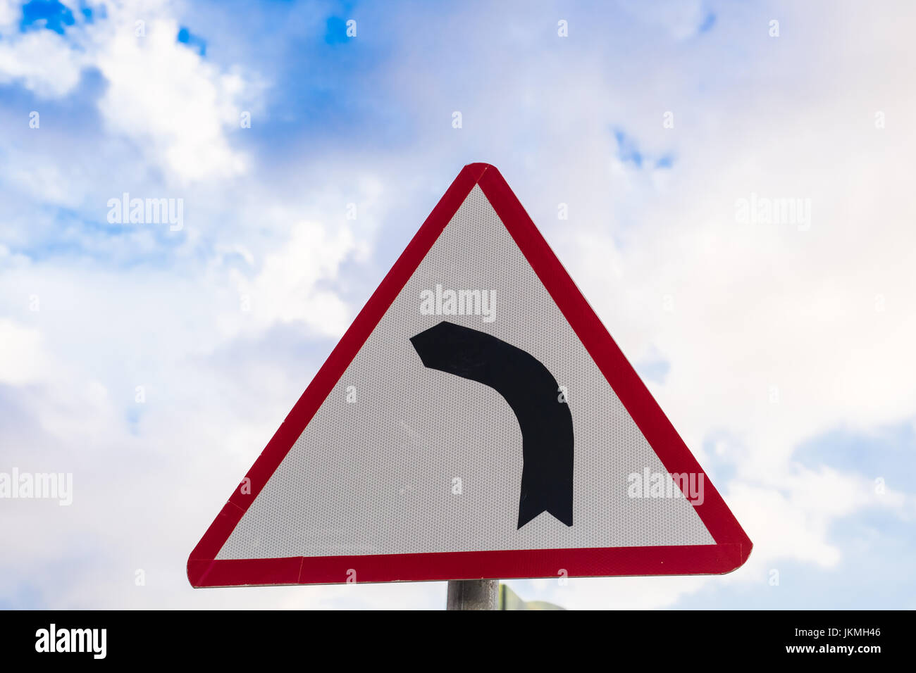 Traffic Sign dangerous, turn left Stock Photo - Alamy