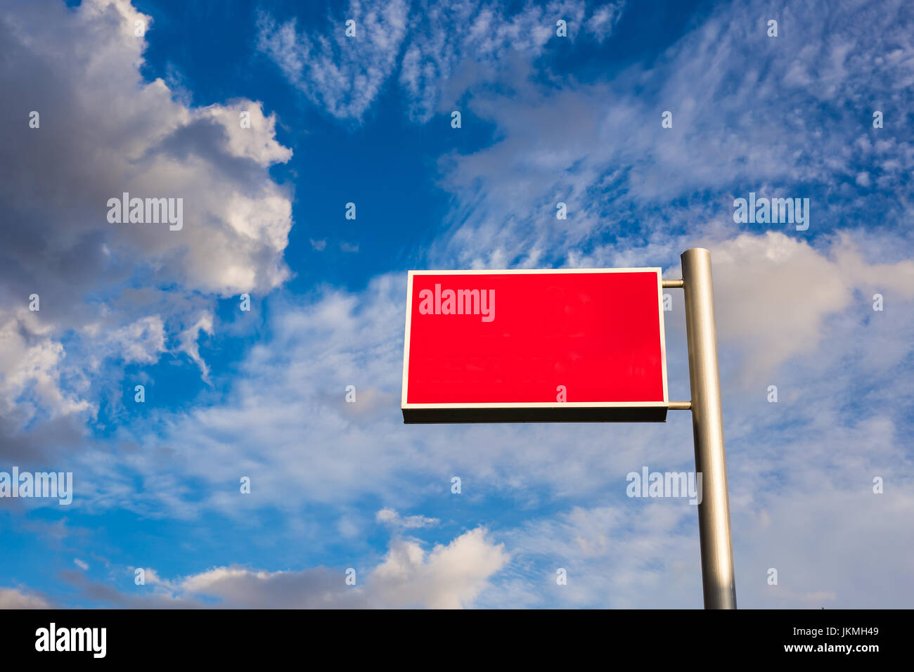 the red advertisement board against blue sky Stock Photo - Alamy