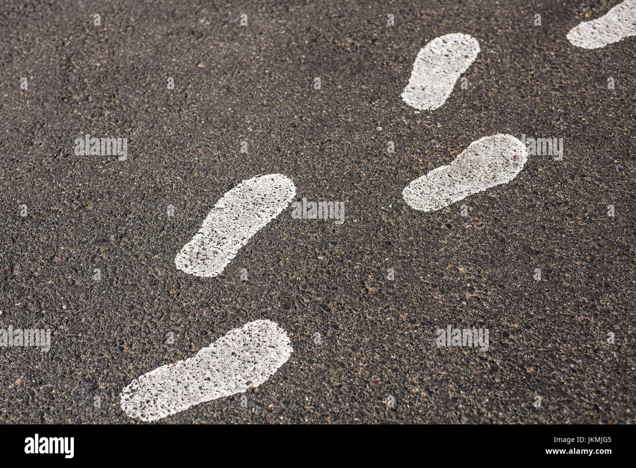 Painted footprints on the pavement Stock Photo - Alamy