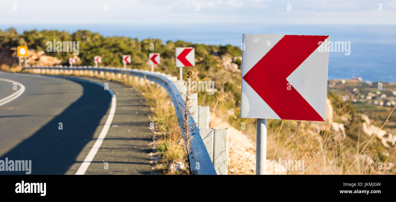 Left Turn Sign: Road signs warn of a sharp turn on a narrow road Stock ...