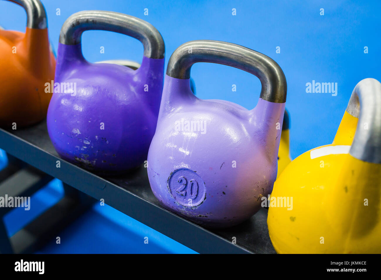 Many colorful dumbbells are on stand at the gym Stock Photo - Alamy