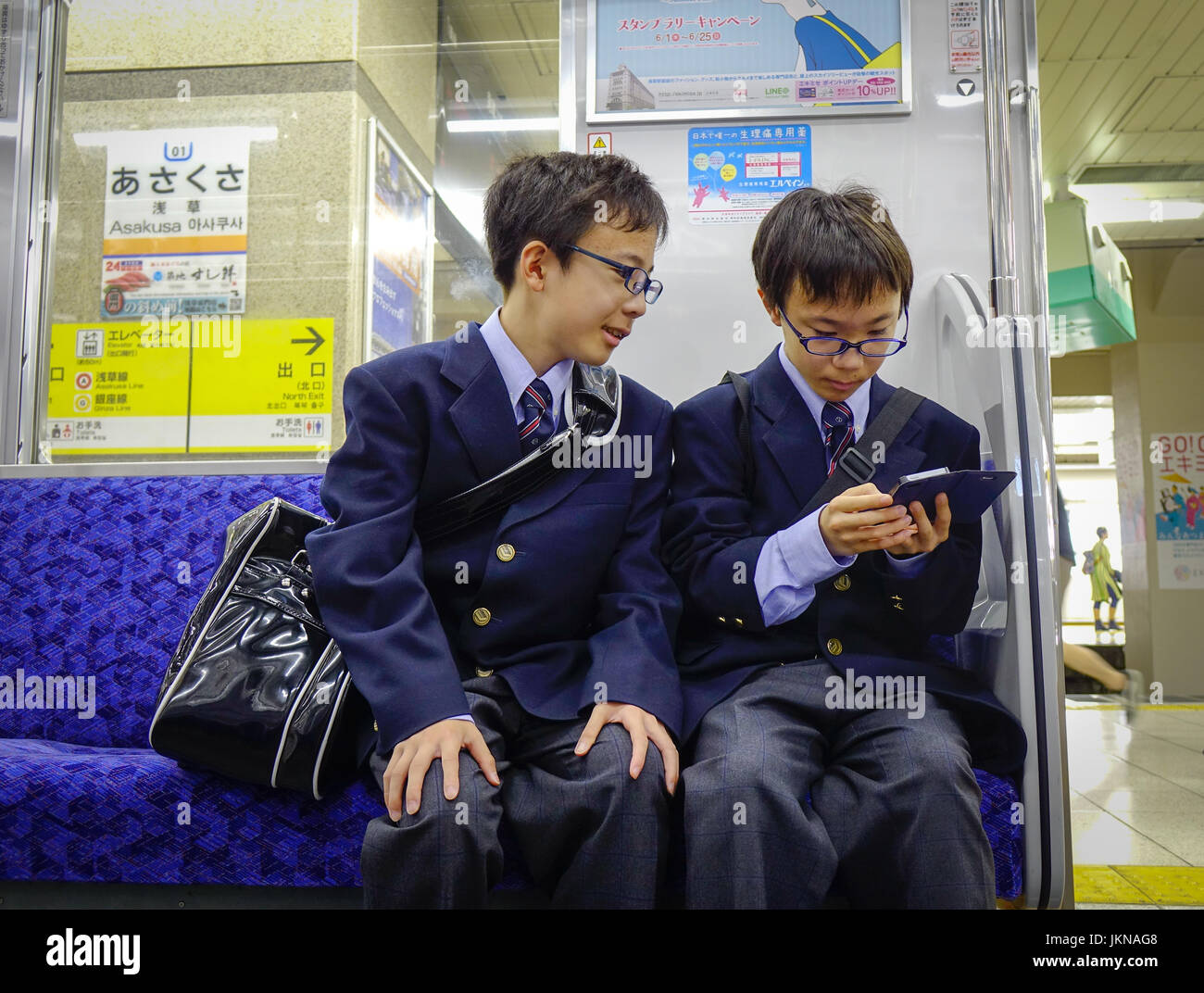 Tokyo, Japan - May 20, 2017. Young students sitting in subway train in ...