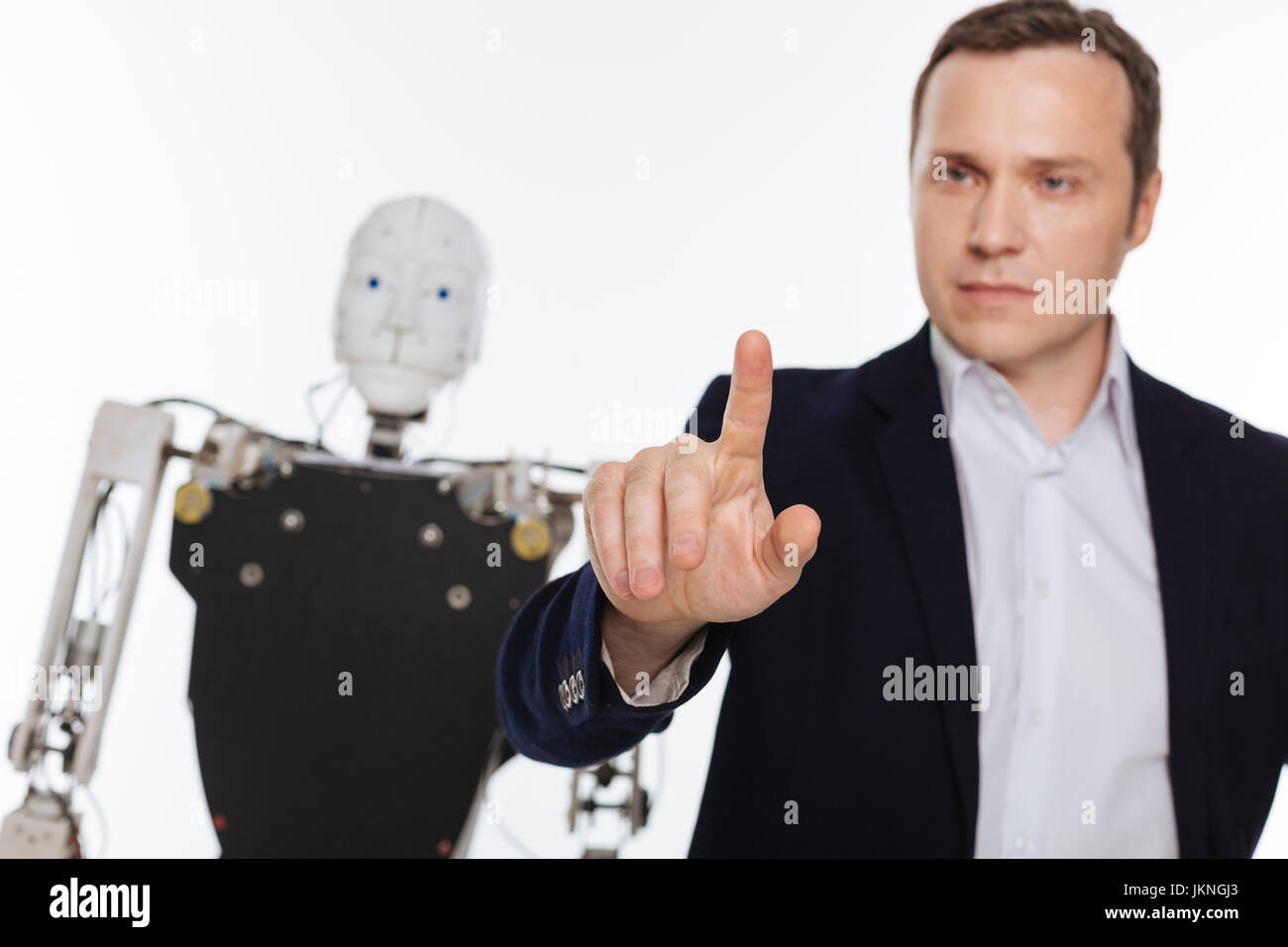 Serious handsome man tapping on a screen Stock Photo - Alamy