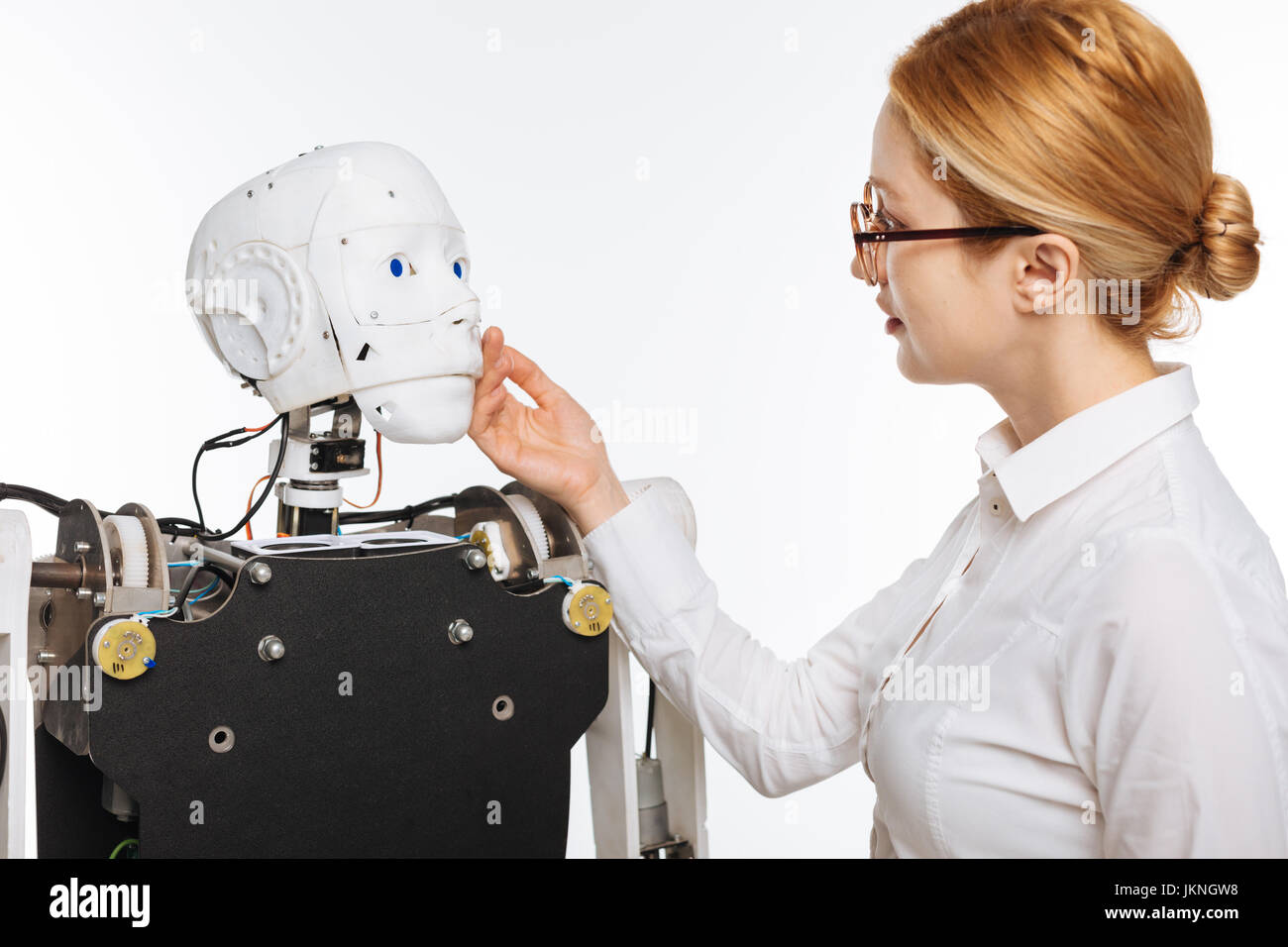 Elegant inspired scientist fascinated by the robot Stock Photo - Alamy