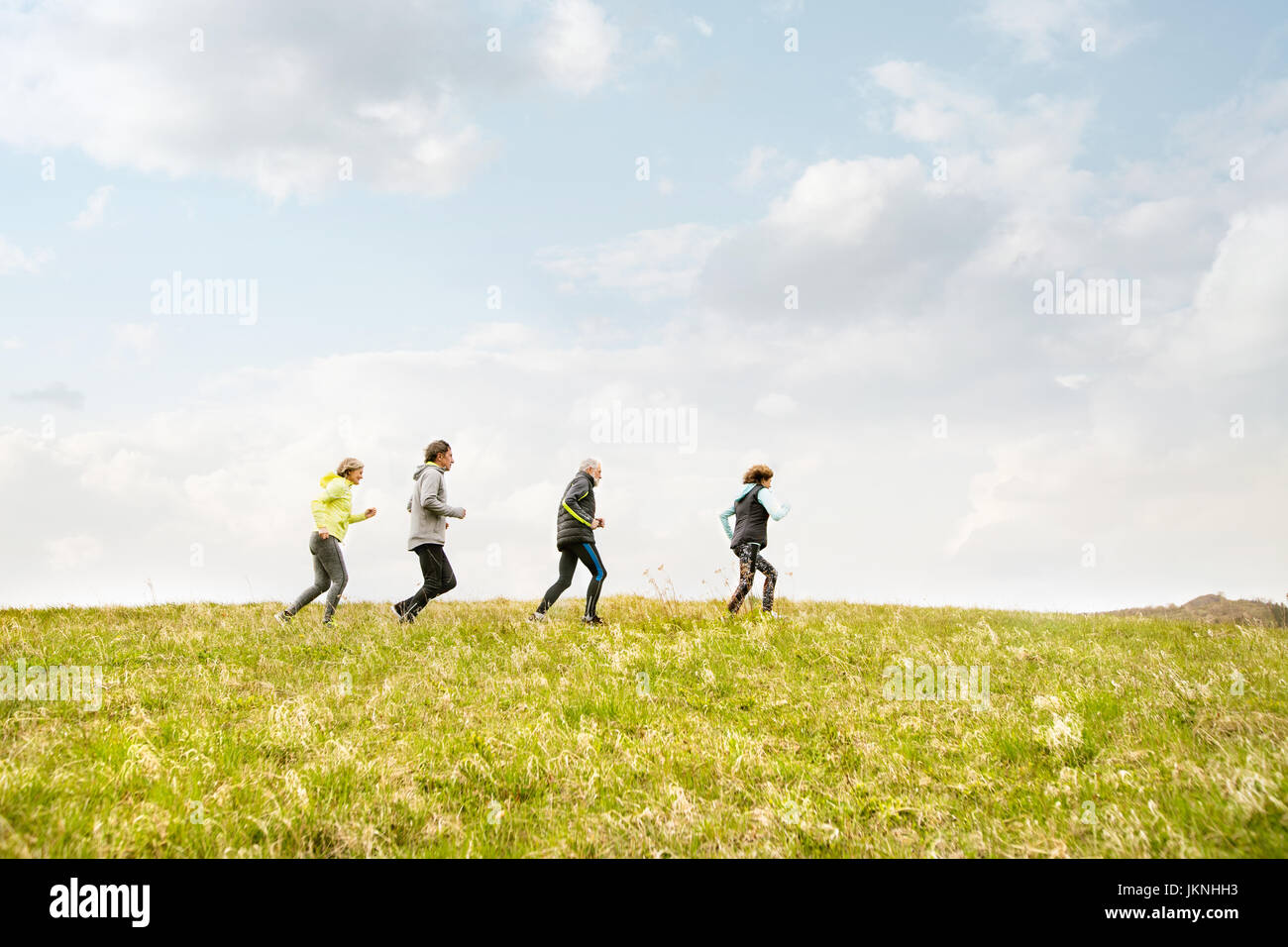 Group of seniors running outside on the green hills Stock Photo - Alamy