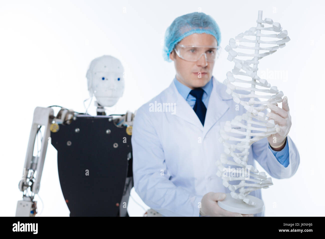 Motivated precise man holding a 3D model of the genome Stock Photo - Alamy