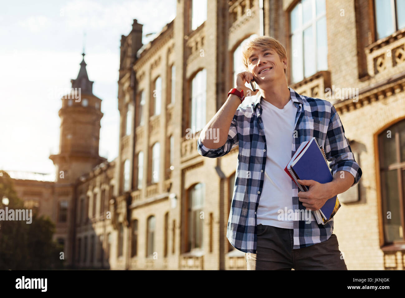 Cheerful lively guy receiving a call Stock Photo - Alamy