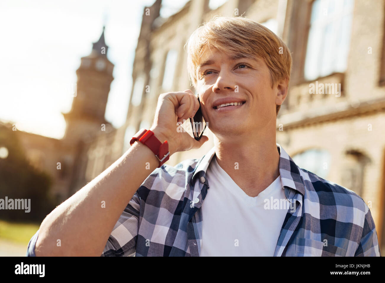 Nice optimistic man receiving good news Stock Photo - Alamy
