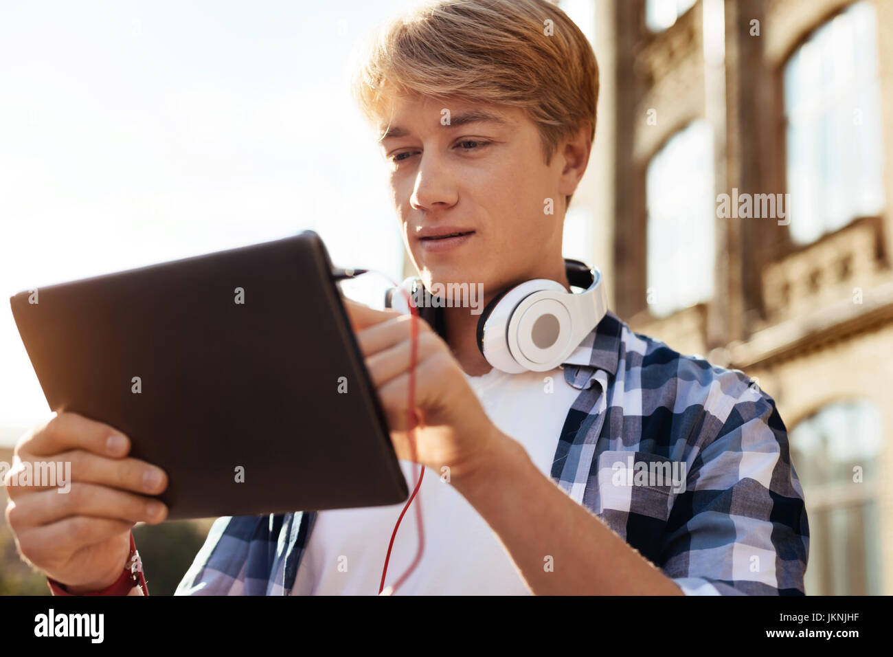 Charming dedicated man finding some information Stock Photo - Alamy