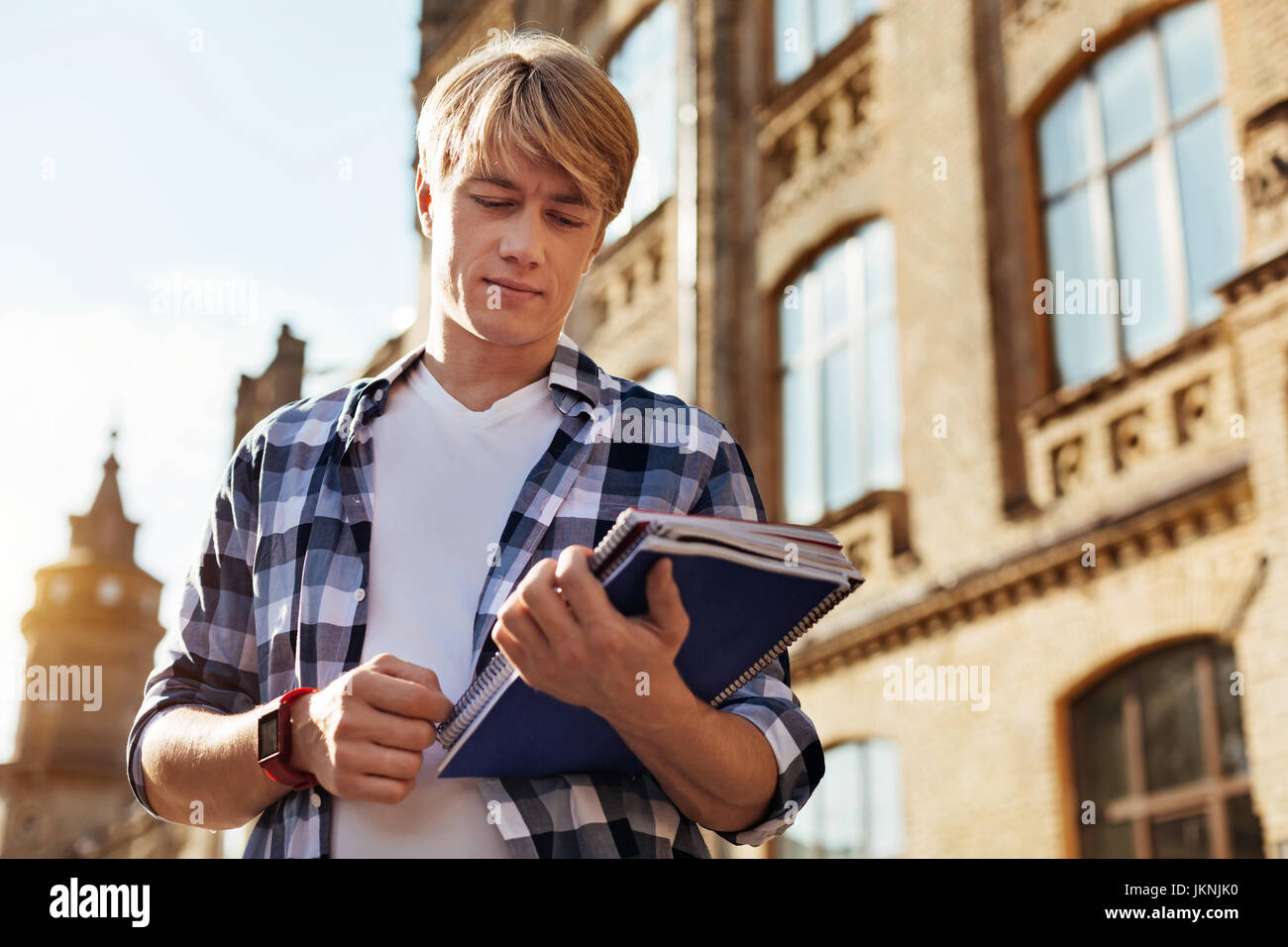 Productive handsome man looking at the schedule Stock Photo - Alamy