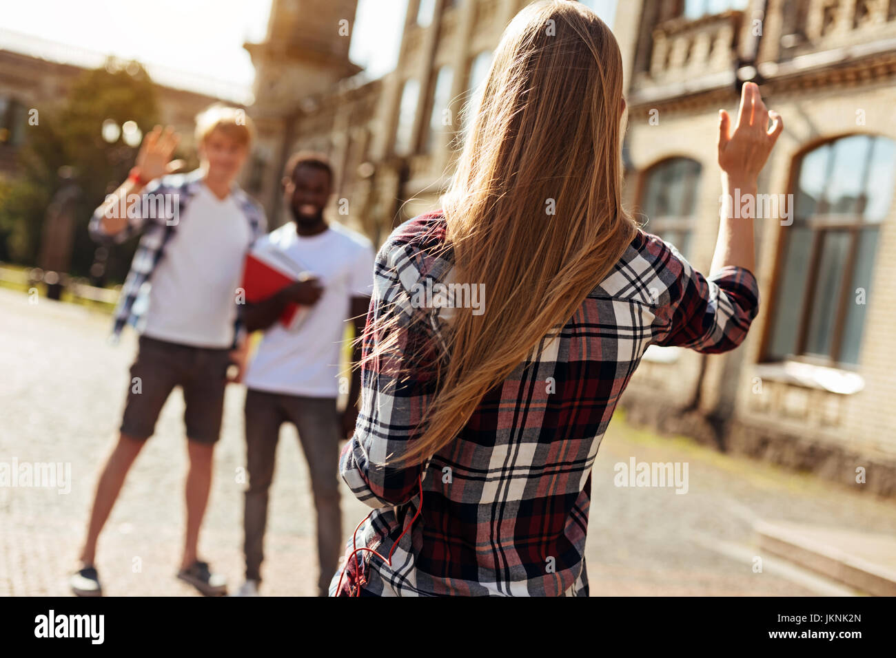 Lovely gorgeous woman greeting her friends Stock Photo - Alamy