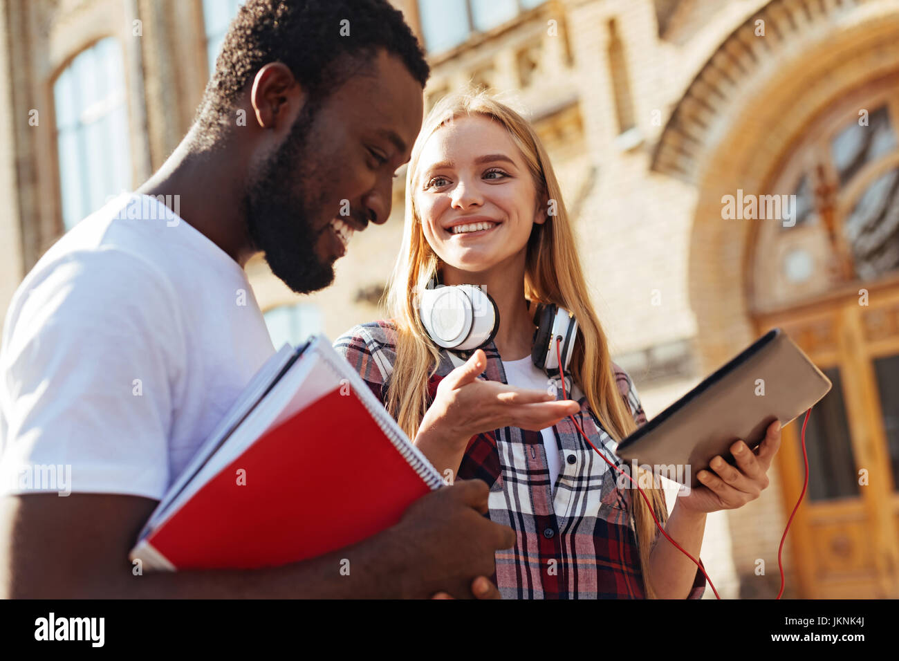 Curious sociable girl meeting up with her friend Stock Photo - Alamy