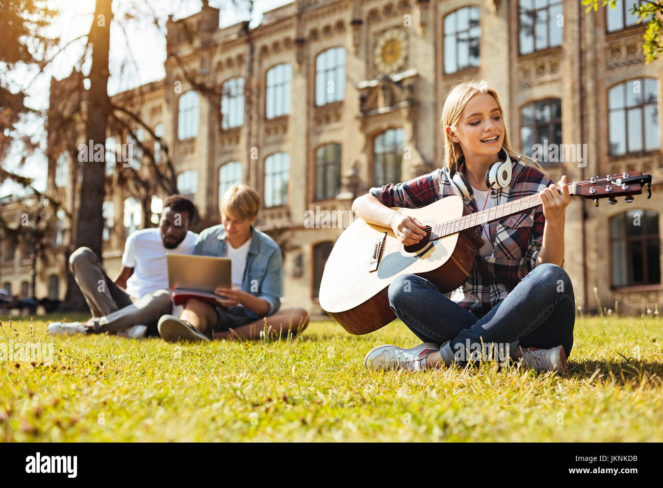 Committed young woman practicing her music skills Stock Photo - Alamy