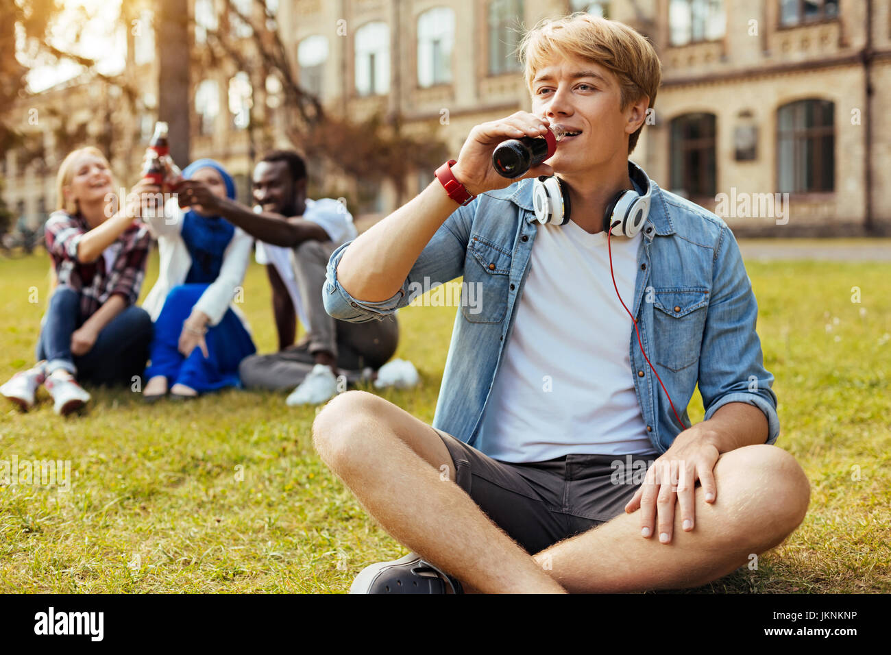 Adventurous easy going man taking a sip Stock Photo - Alamy