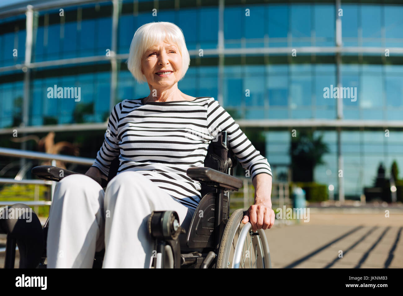 Elegant optimistic aged lady taking a sunbath Stock Photo - Alamy