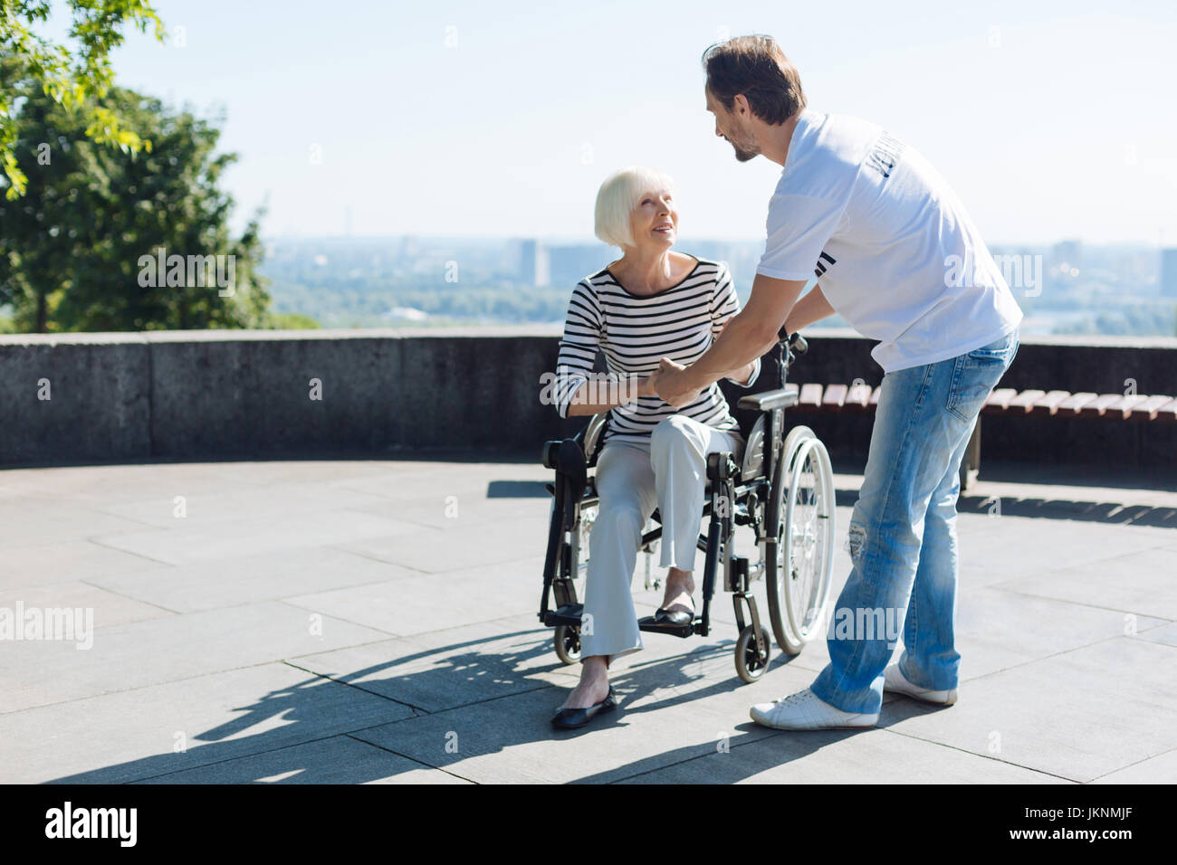 Attentive devoted man making sure lady standing firmly Stock Photo - Alamy