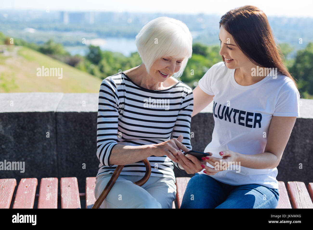 Cheerful nostalgic woman looking through her pictures Stock Photo - Alamy