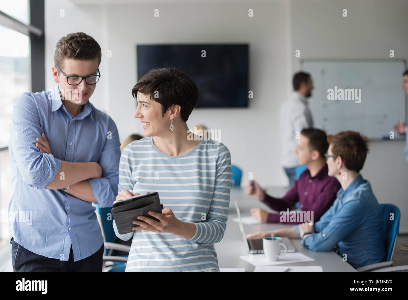 two business people using tablet preparing for next meeting and ...