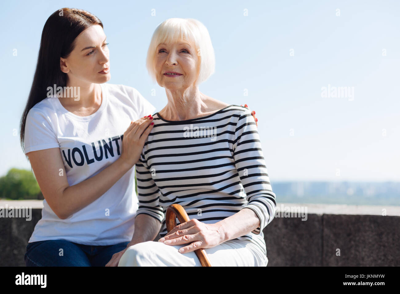 Attentive sincere woman asking if the lady needing something Stock ...