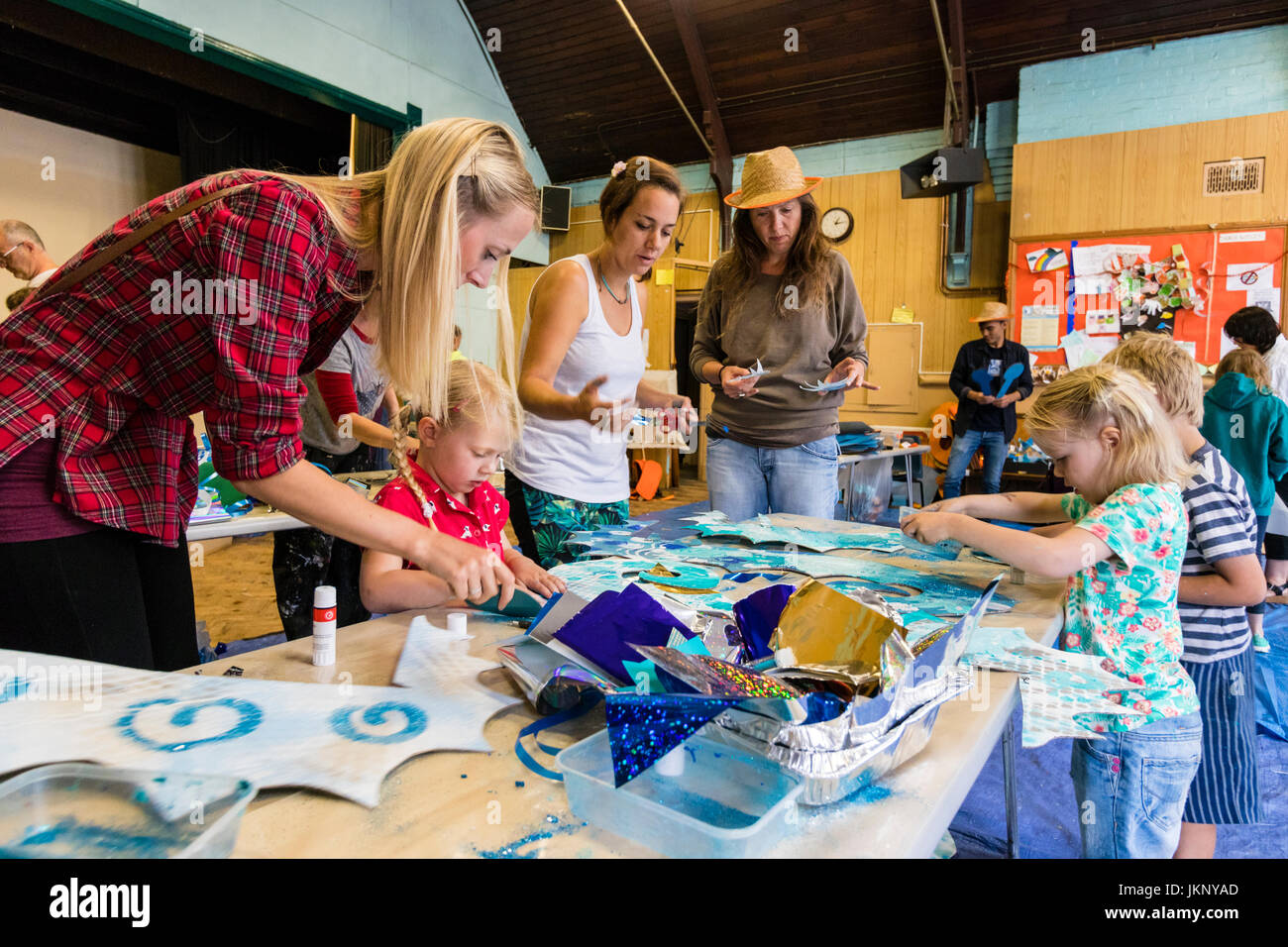 Caucasian adults and children at indoor creative arts and crafts ...