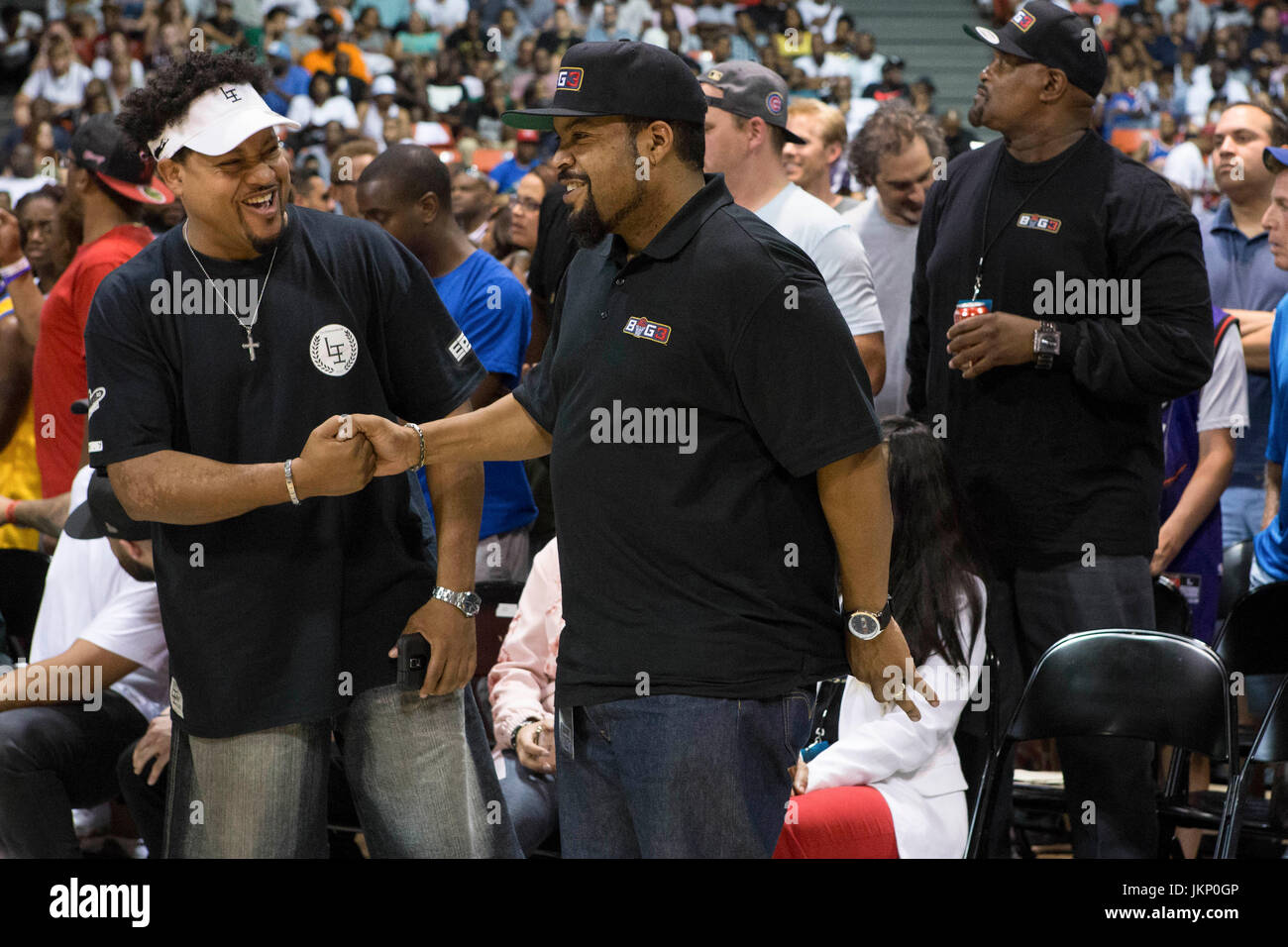 Ice Cube cracks smile while shaking someone's hand standing courtside ...