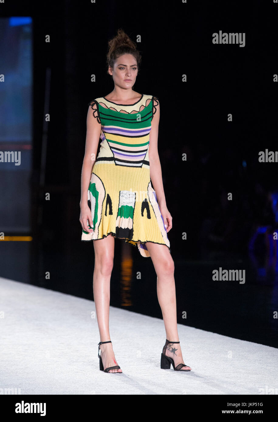 MIAMI BEACH, FL - JULY 23: A model walks the runway during the ...