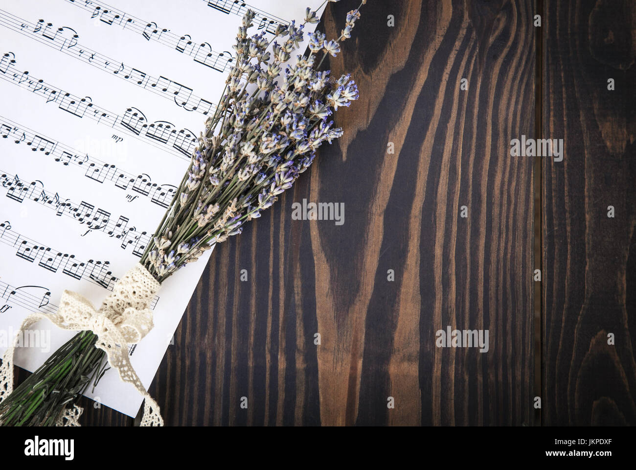 Lavender and paper music notes on old wooden background in vintage ...