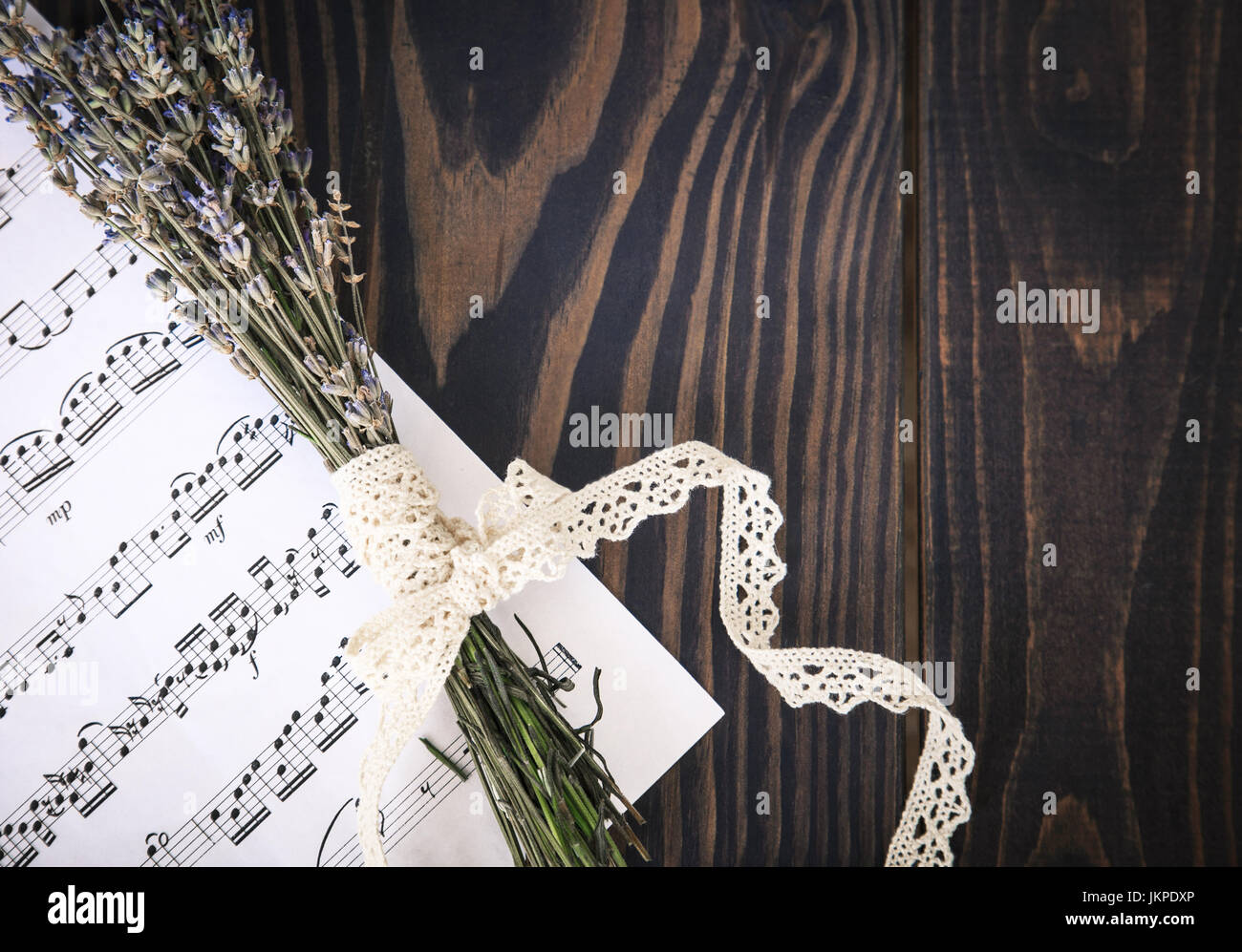 Lavender and paper music notes on old wooden background in vintage ...