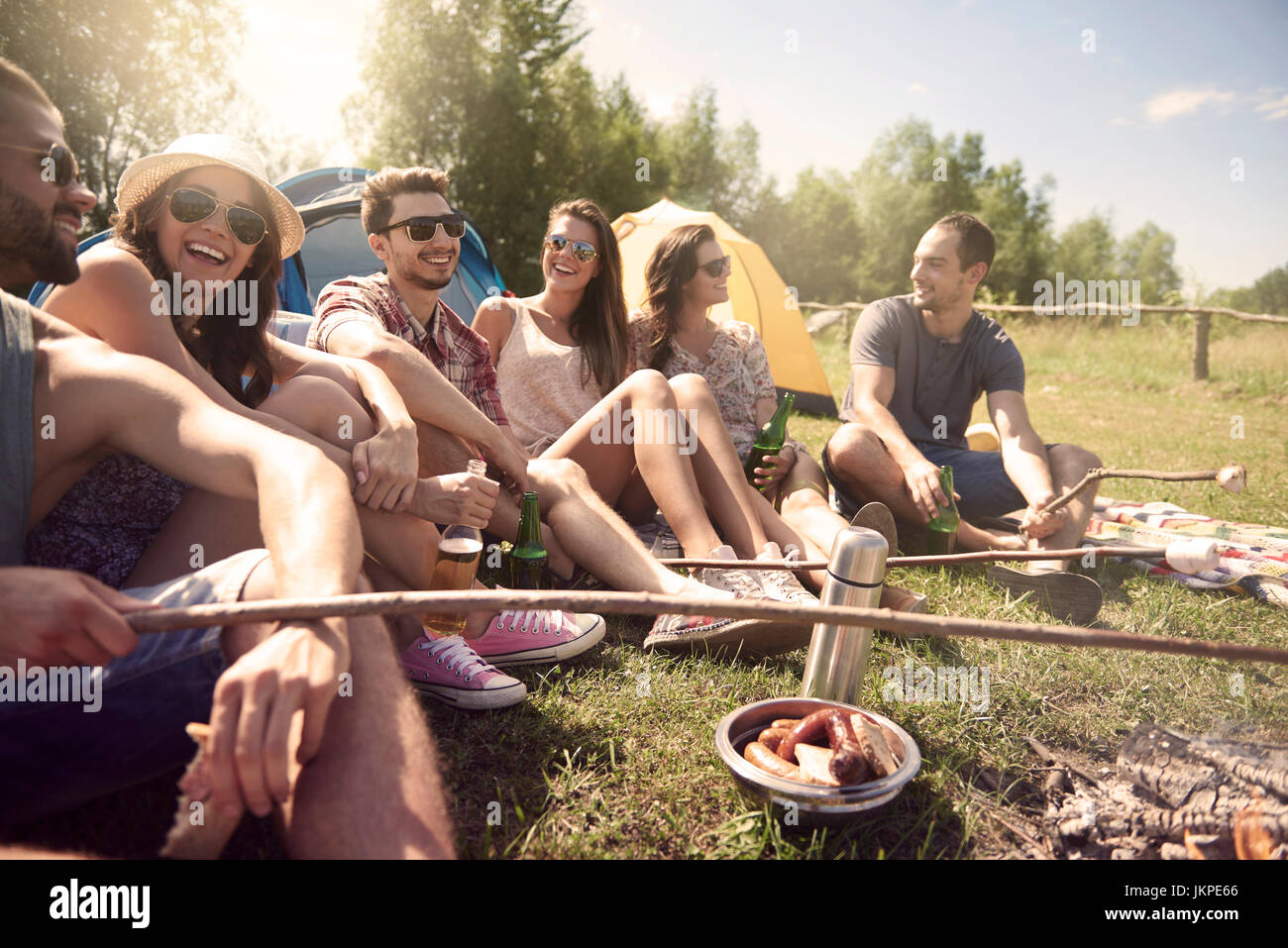 Young people having a camping Stock Photo - Alamy